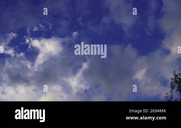 Fast moving white cumulus clouds. Blue sky with several layers of clouds Stock Video Footage - Alamy