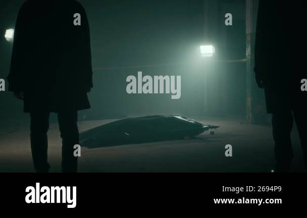 Wide shot of young detective couple wearing black suits approaching ...