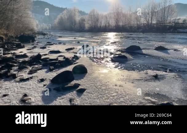 A stunning and beautiful winter river scene featuring frosty trees ...