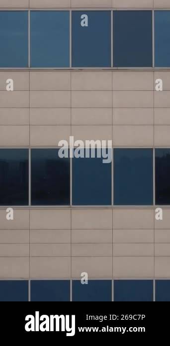 Drone view moving up from hospital window, view of hospital blocks ...