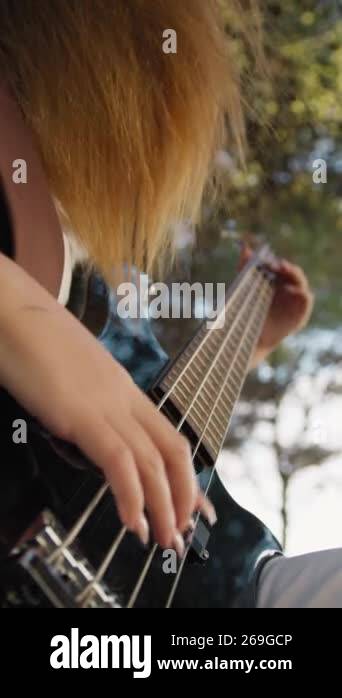 Girl playing bass guitar in the nature near the beach Stock Video ...