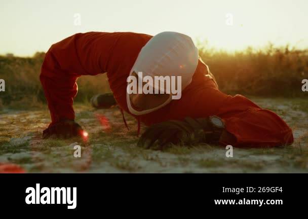Astronaut in orange suit lands .on a hostile planet Stock Video Footage ...