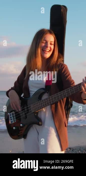 Girl playing bass guitar in the nature near the beach Stock Video ...