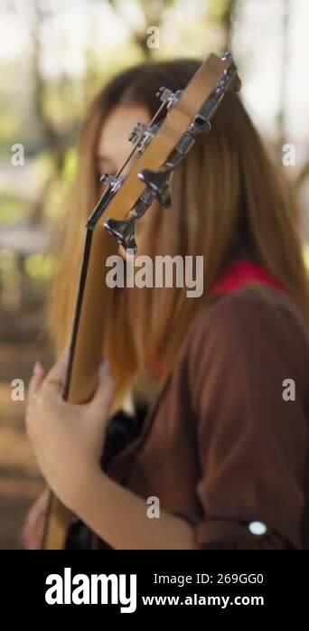 Girl playing bass guitar in the nature near the beach Stock Video ...