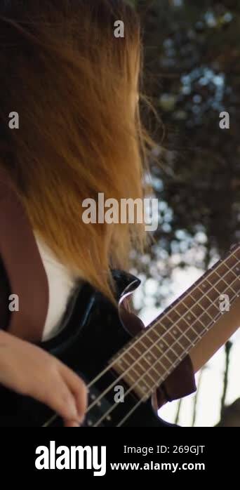 Girl playing bass guitar in the nature near the beach Stock Video ...