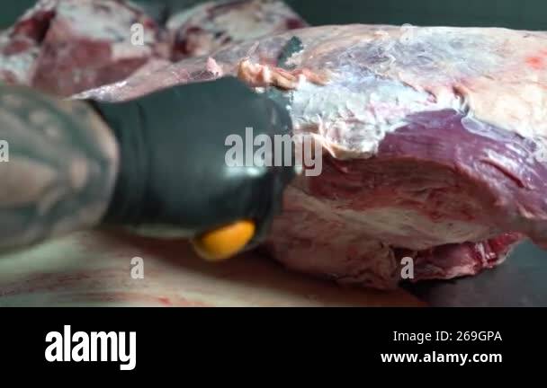 Butcher removing membrane from beef cut Stock Video Footage - Alamy