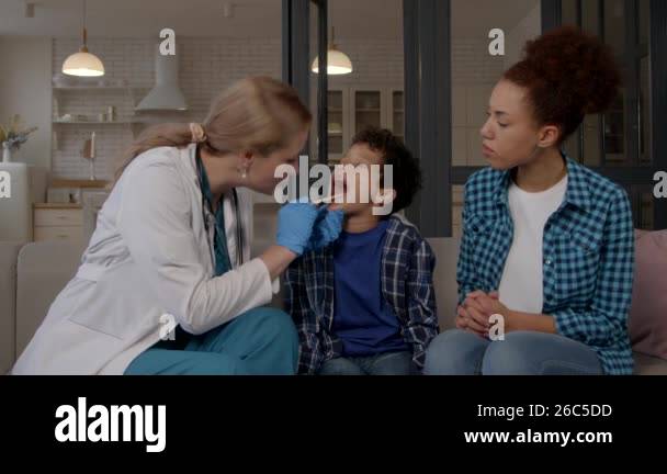 Portrait of Friendly woman ENT doctor in uniform visiting worried ...