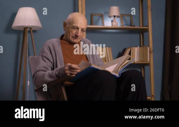 Senior older man watching pictures in photo album, remember, nostalgia ...