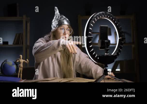 Strange crazy vlogger with cellphone, paranoid woman streaming at home ...