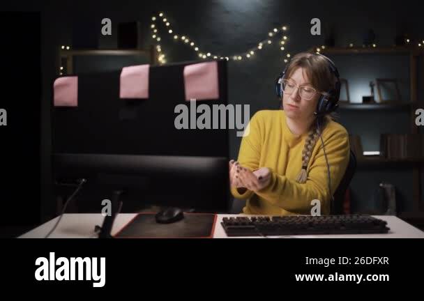 Gamer talking with team on microphone playing in online video game ...