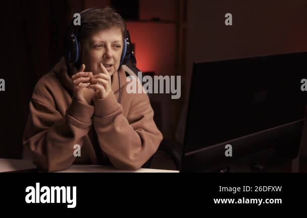 Woman streamer, gamer, blogger, vlogger engages in thoughtful planning ...