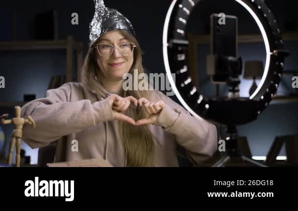 Strange crazy vlogger with cellphone, paranoid woman streaming at home ...