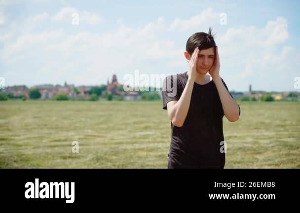 Teenage boy dancing head dance, moving hands around face, closing eyes ...