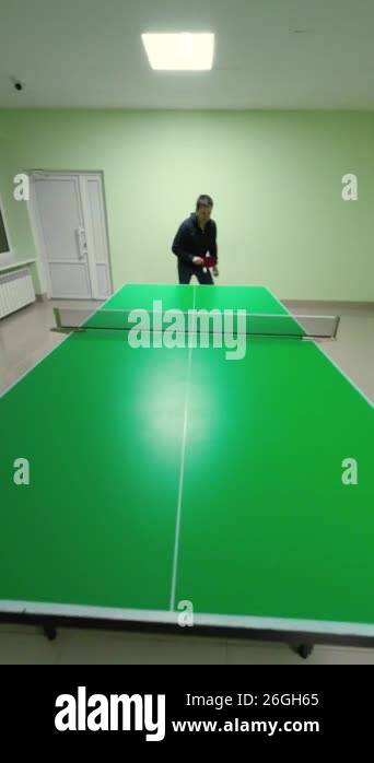 Immersive vertical POV footage of table tennis match showing ...