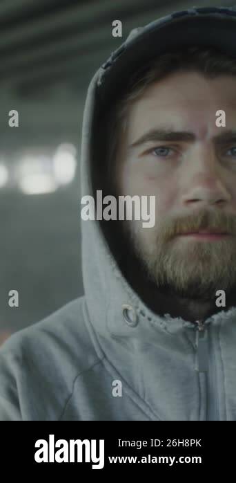 Vertical close-up portrait of Caucasian homeless man wearing cap and ...