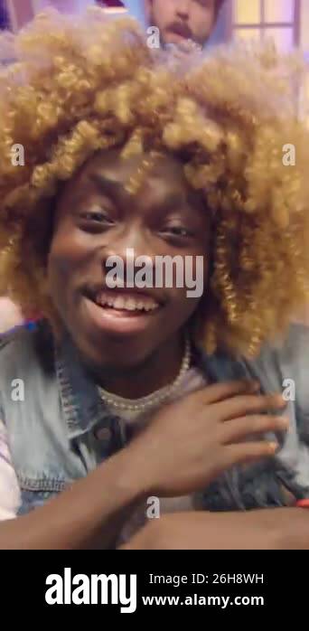 Vertical UGC shot of carefree Black tipsy guy dancing on camera with ...
