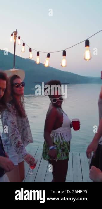 Vertical view from above of group of diverse young friends dancing with ...