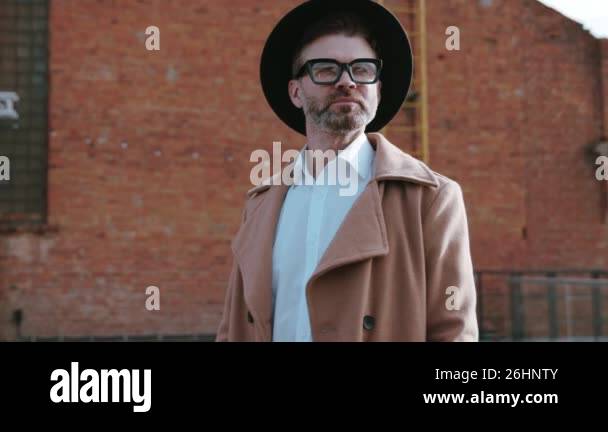 Handsome middle-aged author man staying on a terrace looking around ...