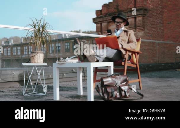 Handsome smiling sociable man in fashion outfit chatting on a ...