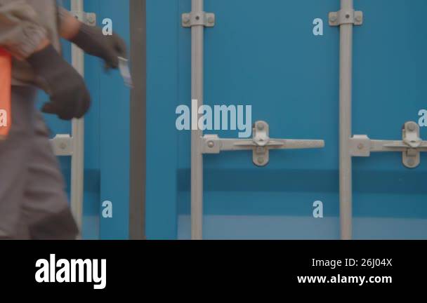 A worker closes the lock of an industrial container. High quality 4k ...