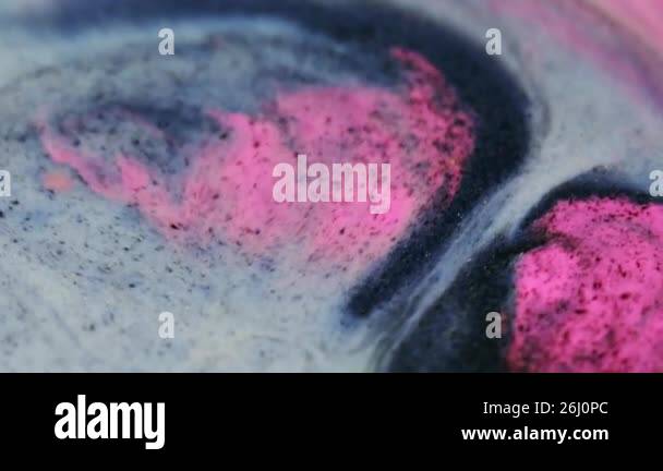 Fluid ink. Art reaction. Emergence of pink pigment on white enamel ...