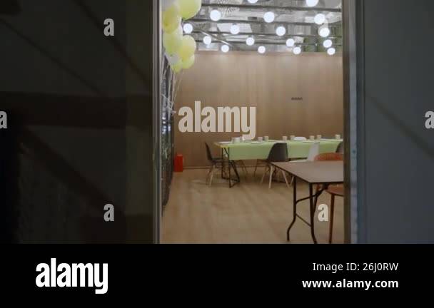 A large indoor space with many tables and a big climbing structure for ...