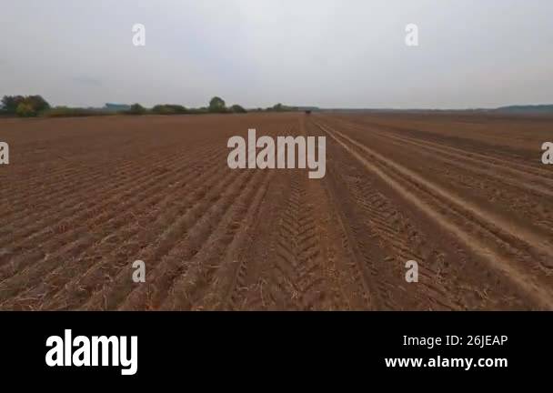 FPV flight over countryside meadows. Large rural agricultural field ...