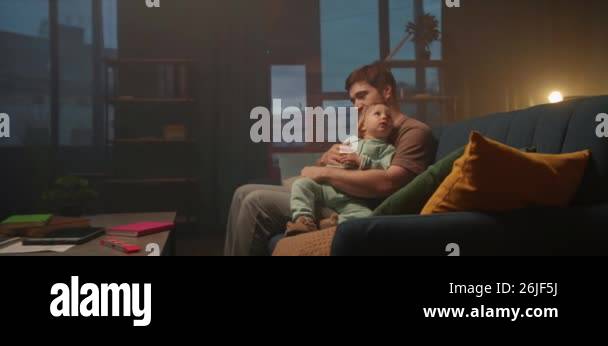 Footage of cute little daughter sitting on daddys lap. Adorable baby ...