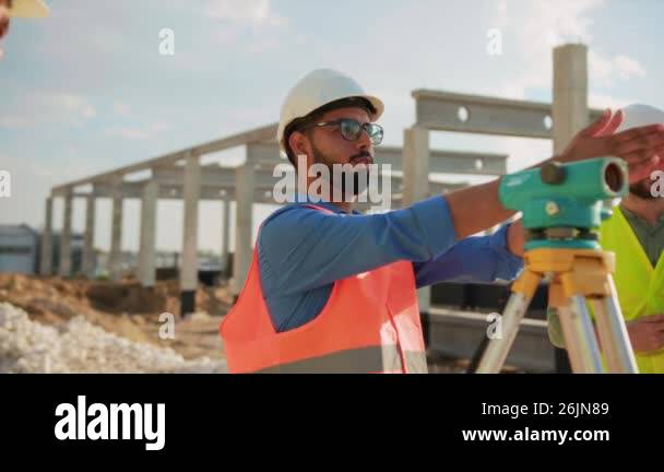 Outdoors a few engineers talking about a construction project use ...