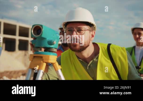 Man use optical levels talking with engineers about a construction ...