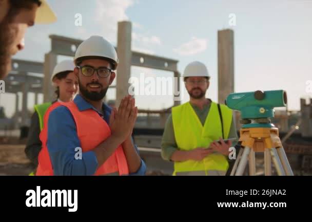 Group of engineers have conversations about a construction project use ...