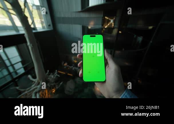 Horizontal footage of Caucasian young man using smartphone in vertical ...
