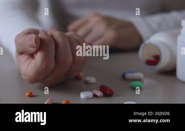 A dramatic scene depicting a potential overdose with pills scattered on ...