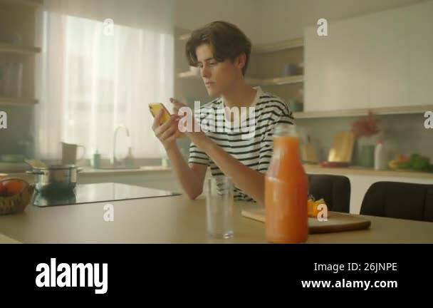 360 degree tracking shot kitchen. Shot of focused handsome young ...