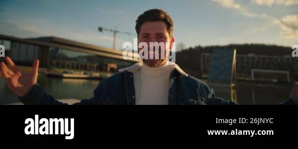 Happy young man smiling feel wonder gestures look around. In the ...
