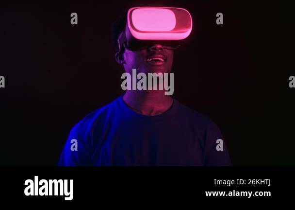 A confident millennial man with a cool style is immersed in virtual ...