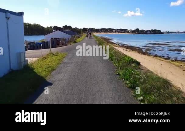 Camera dollying on a narrow road along a beach Stock Video Footage - Alamy