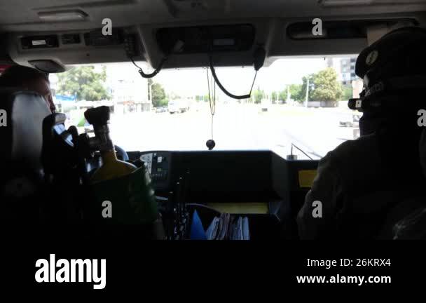 Professional firemen in full equipment driving on fire engine to an ...