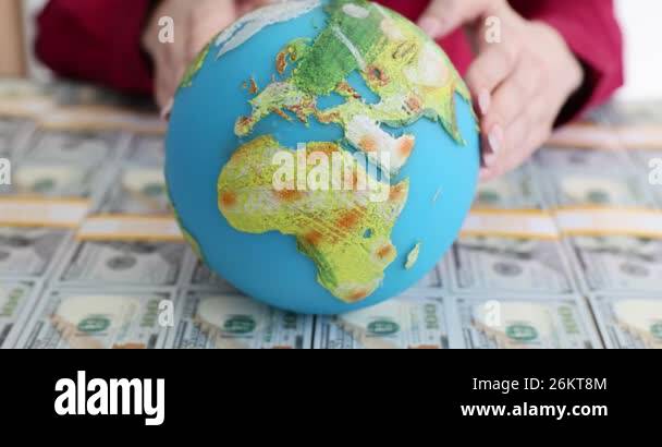 Studying the world economy with a globe and money. World money market ...