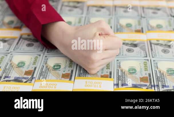 Hand clenched into a fist and stacks of money. Psychology of poverty ...