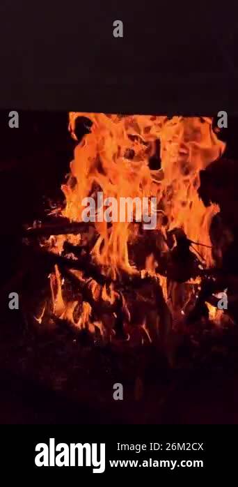 Firewood Burning With Bright Flames in a Dark Background in slow motion ...