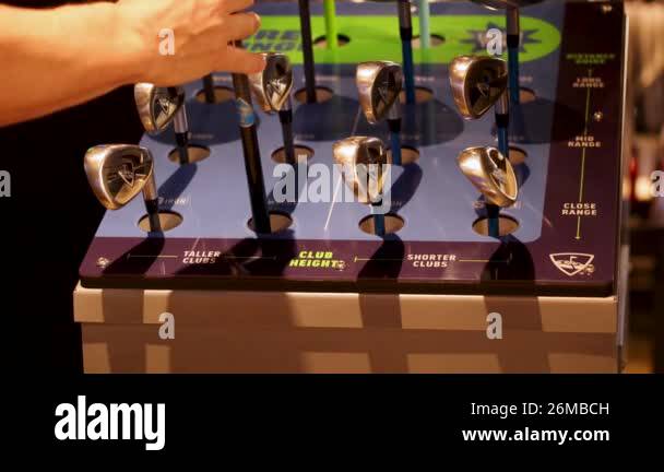 Hands choosing golf clubs from a display Stock Video Footage - Alamy