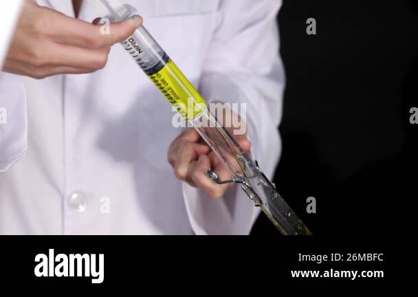 Scientist conducts experiment with syringe and beaker Stock Video ...