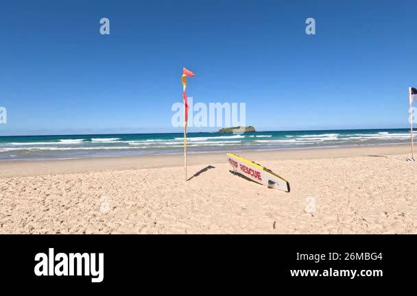 Flags marking safe swimming area on beach Stock Video Footage - Alamy