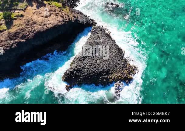 Hexagonal rock formations meet turquoise ocean waves Stock Video ...