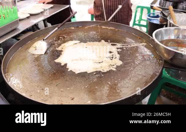 Cooking an egg on a hot griddle outdoors Stock Video Footage - Alamy