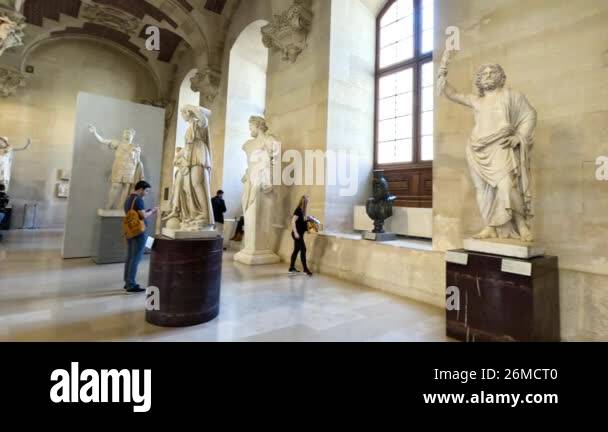 People exploring statues in the Louvre Museum Stock Video Footage - Alamy