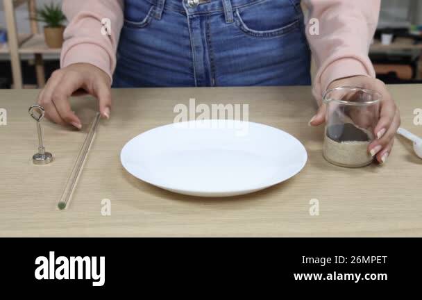 Demonstrating magnetic properties using sand and a magnet Stock Video ...