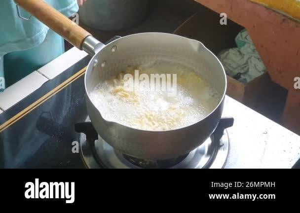 POV hands cooking instant noodle soup at home. Asian female hand ...
