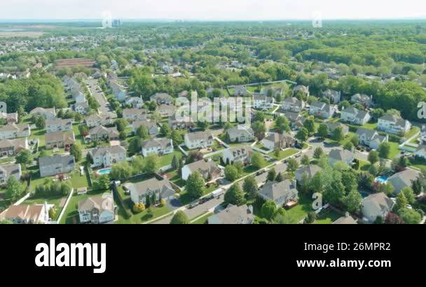 Birds eye perspective captures a sprawling suburb with tree-lined ...